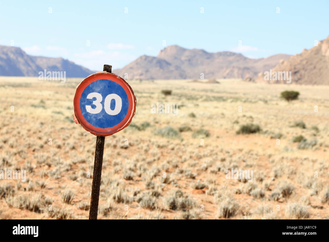 Old speed road sign in desert and mountain landscape Stock Photo - Alamy