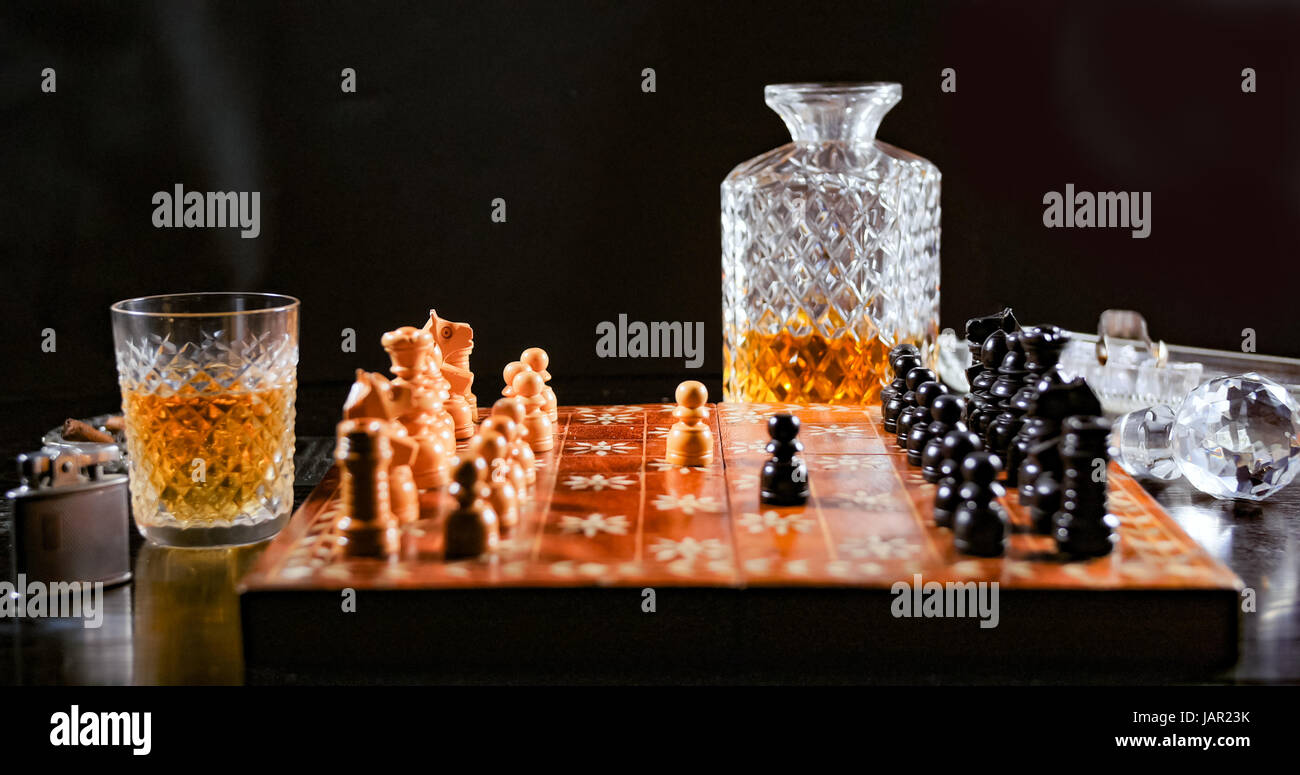 Playing a game of chess with a glass of whiskey and a cigar Stock Photo ...