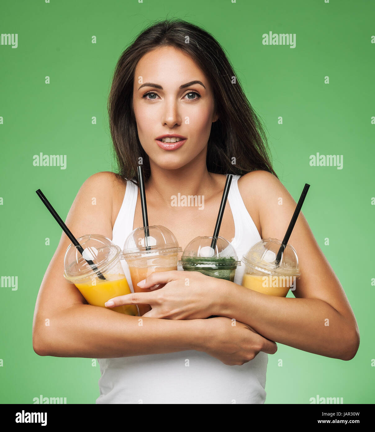 Happy woman drinking smoothie and juice Stock Photo - Alamy