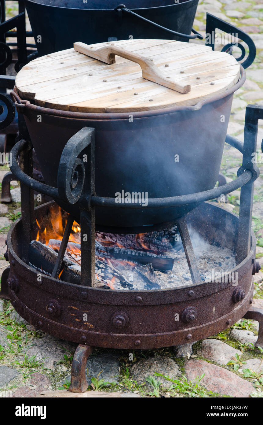 Old pot cooking over campfire hi-res stock photography and images - Alamy