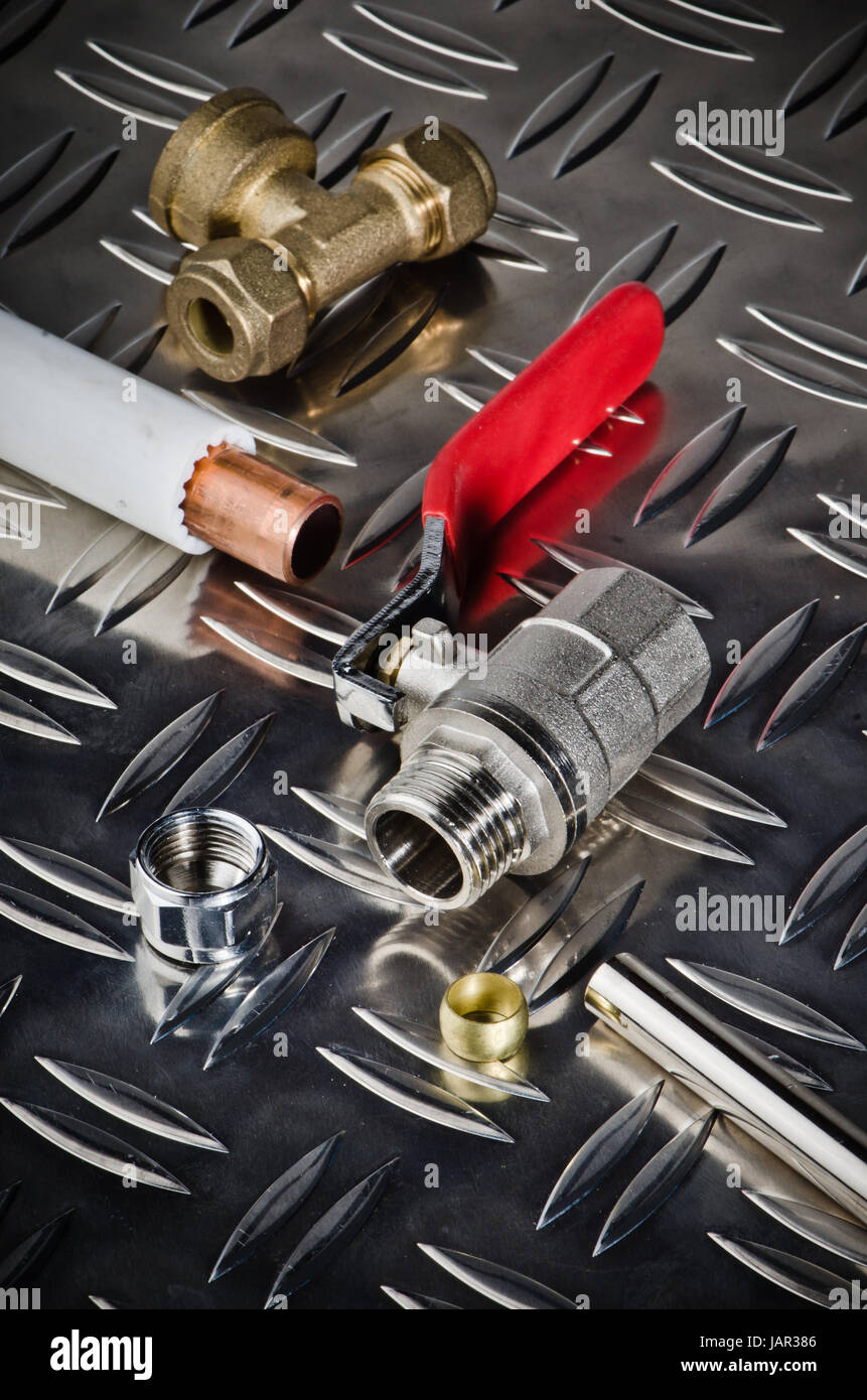 Plumbing inlet pipe valve on a metal surface Stock Photo - Alamy