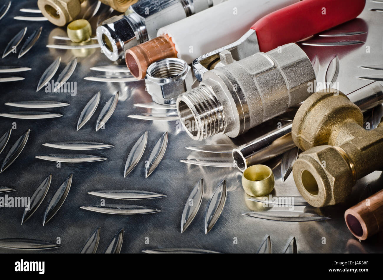 Plumbing inlet pipe valve on a metal surface Stock Photo - Alamy