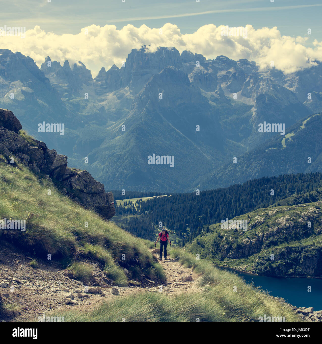Trekker walking a picturesque mountain trail Stock Photo - Alamy