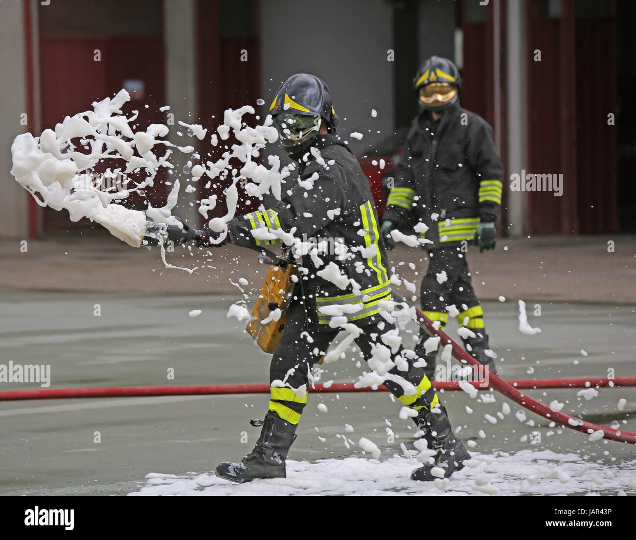 Firefighters while extinguishing the fire with a special fire ...