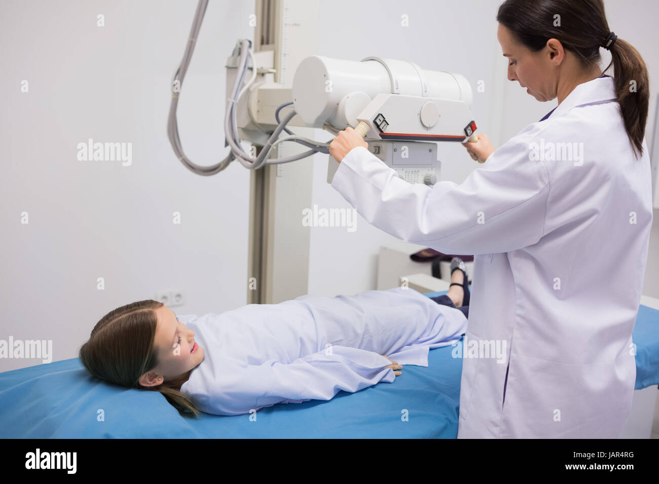 Female doctor doing a radiography on a girl in a hospital Stock Photo ...