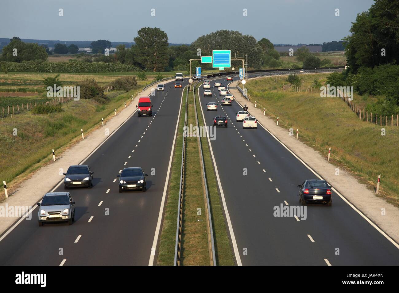 Highway with cars passing by Stock Photo - Alamy