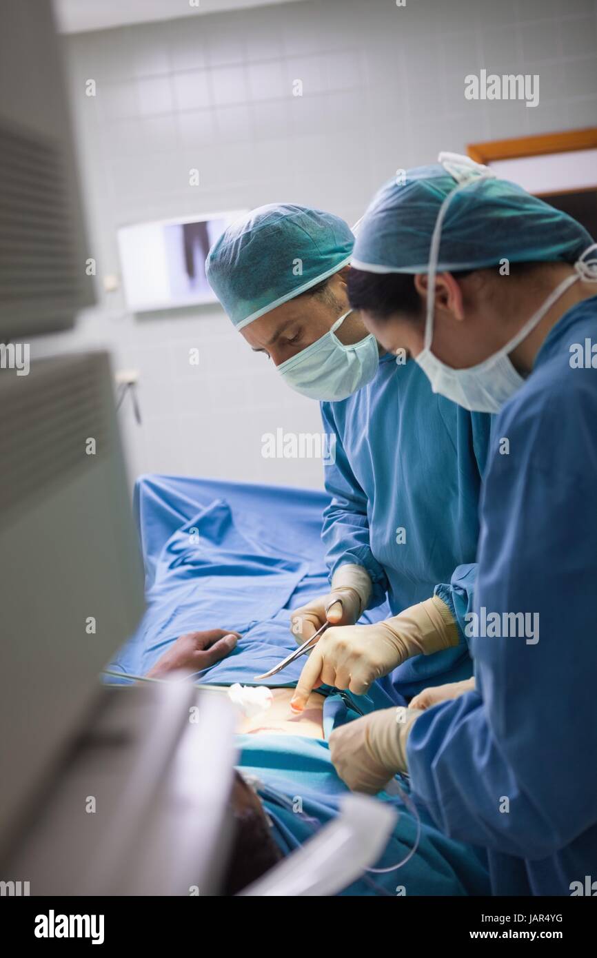 Surgical team doing operation patient hi-res stock photography and ...