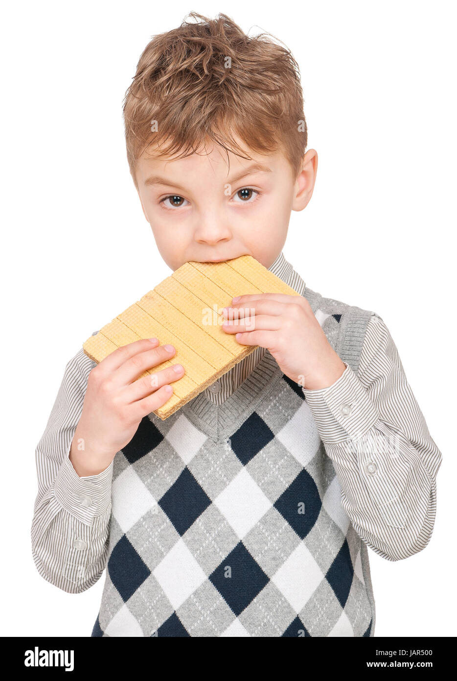 Portrait of happy little boy eating waffle isolated on white background ...