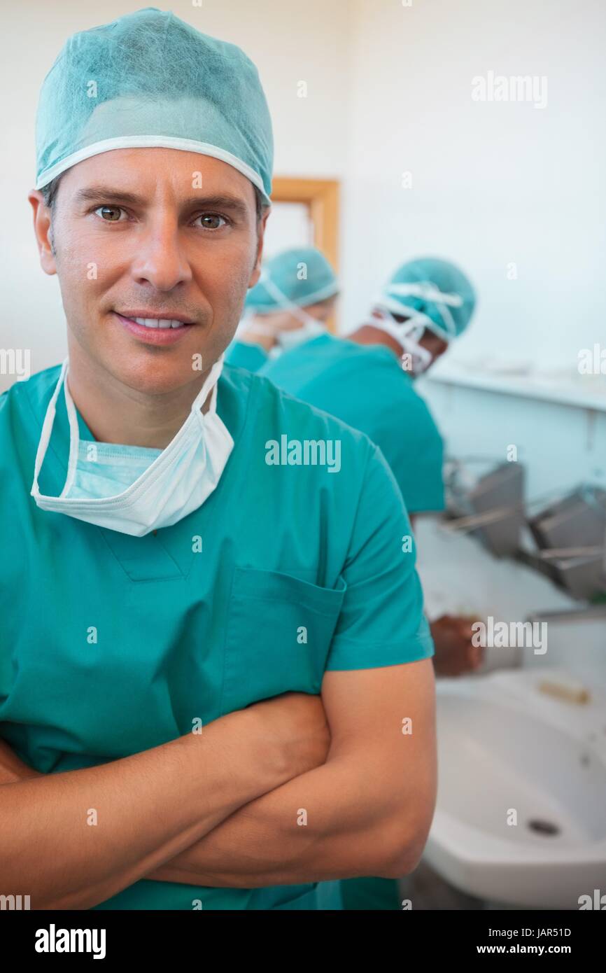 Smiling surgeon with his arms crossed Stock Photo - Alamy