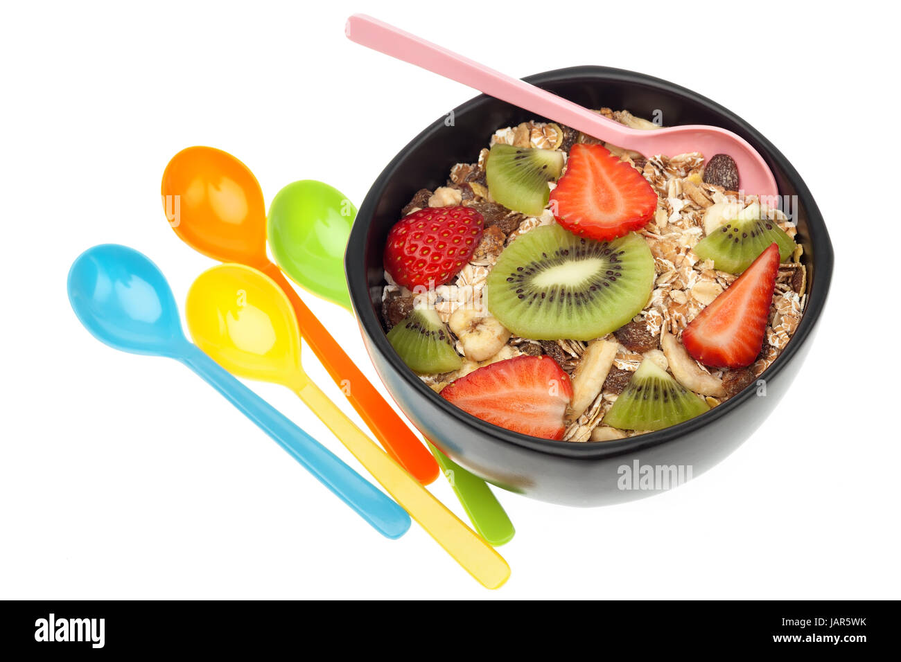Muesli and fruits in bowl isolated on white background Stock Photo - Alamy
