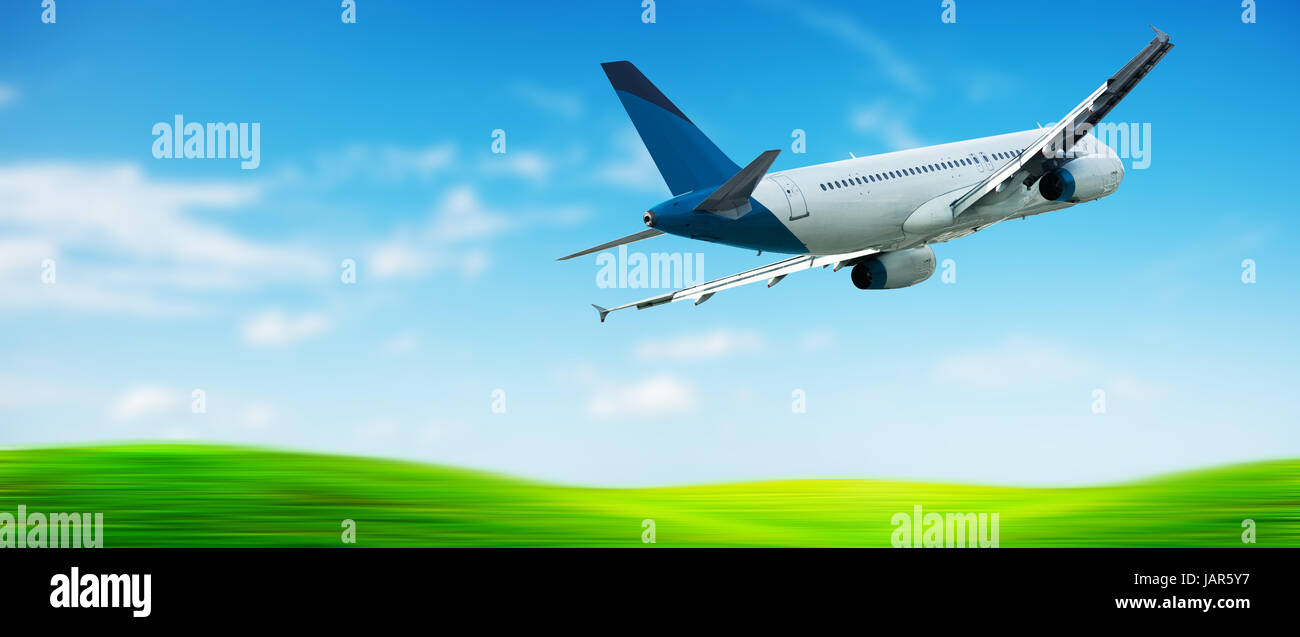 Jet plane over the field of green Stock Photo - Alamy
