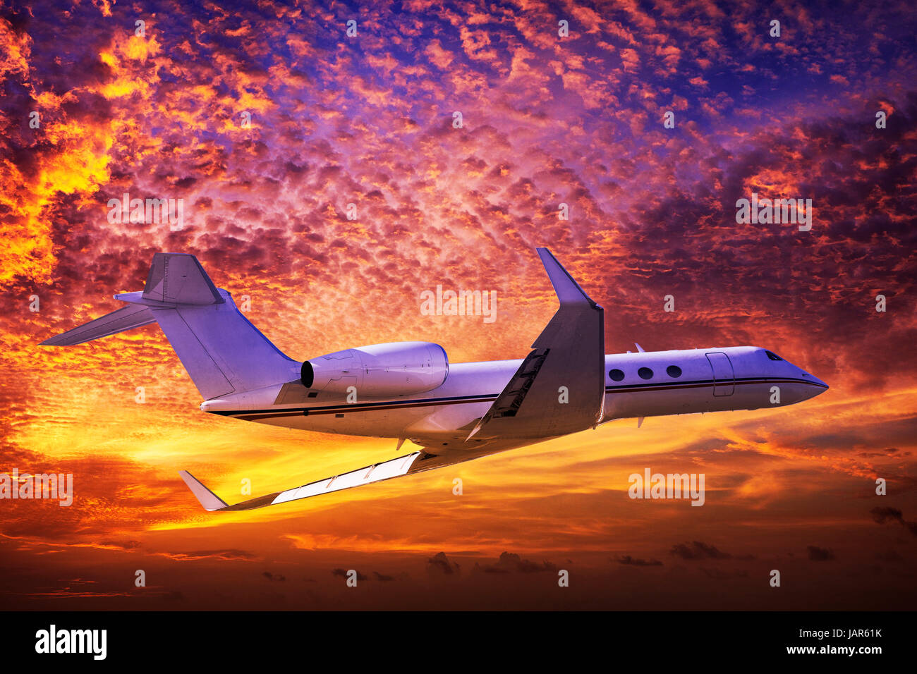 Private jet cruising in a sunset sky Stock Photo - Alamy