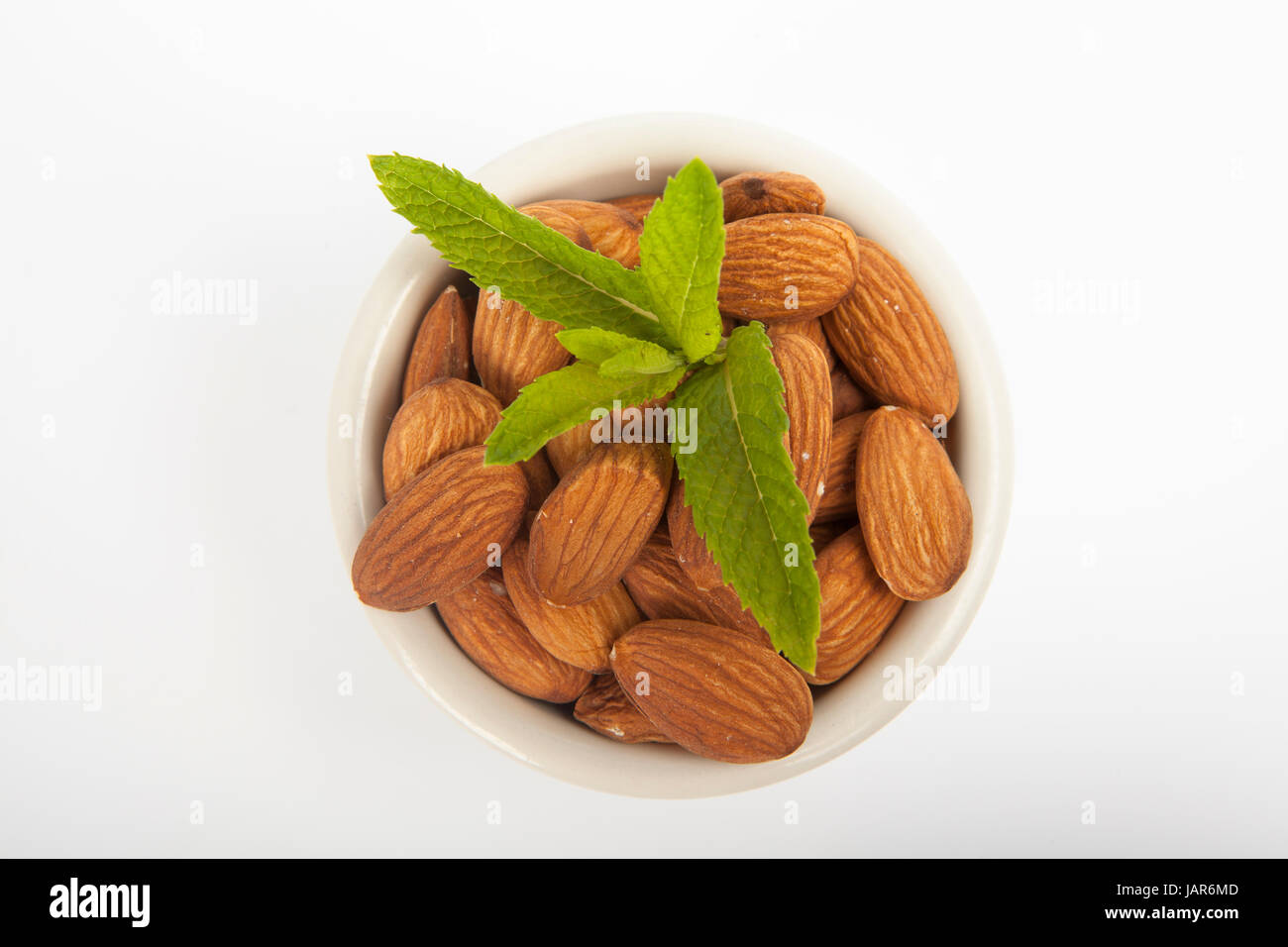 Many almonds isolated on white background Stock Photo - Alamy