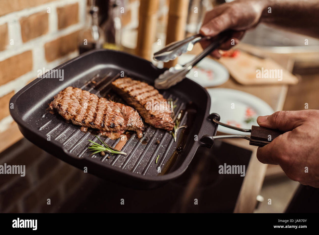Man cooking steaks Stock Photo - Alamy