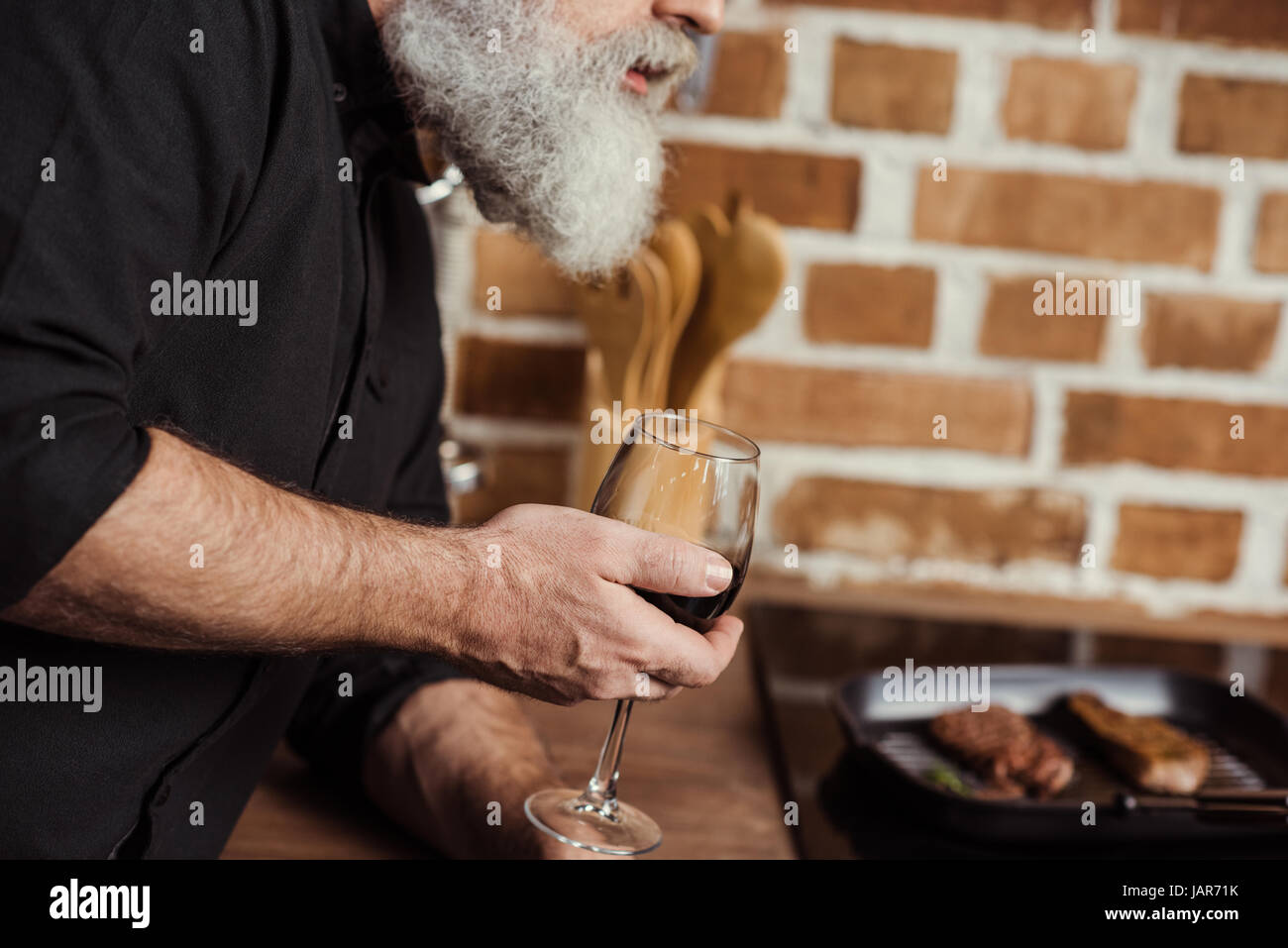 Man holding wine glass Stock Photo - Alamy
