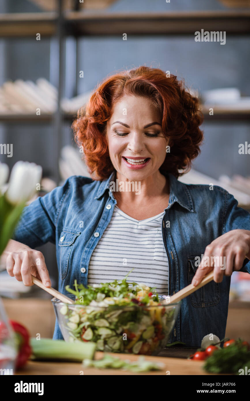 Woman cooking vegetable salad Stock Photo - Alamy