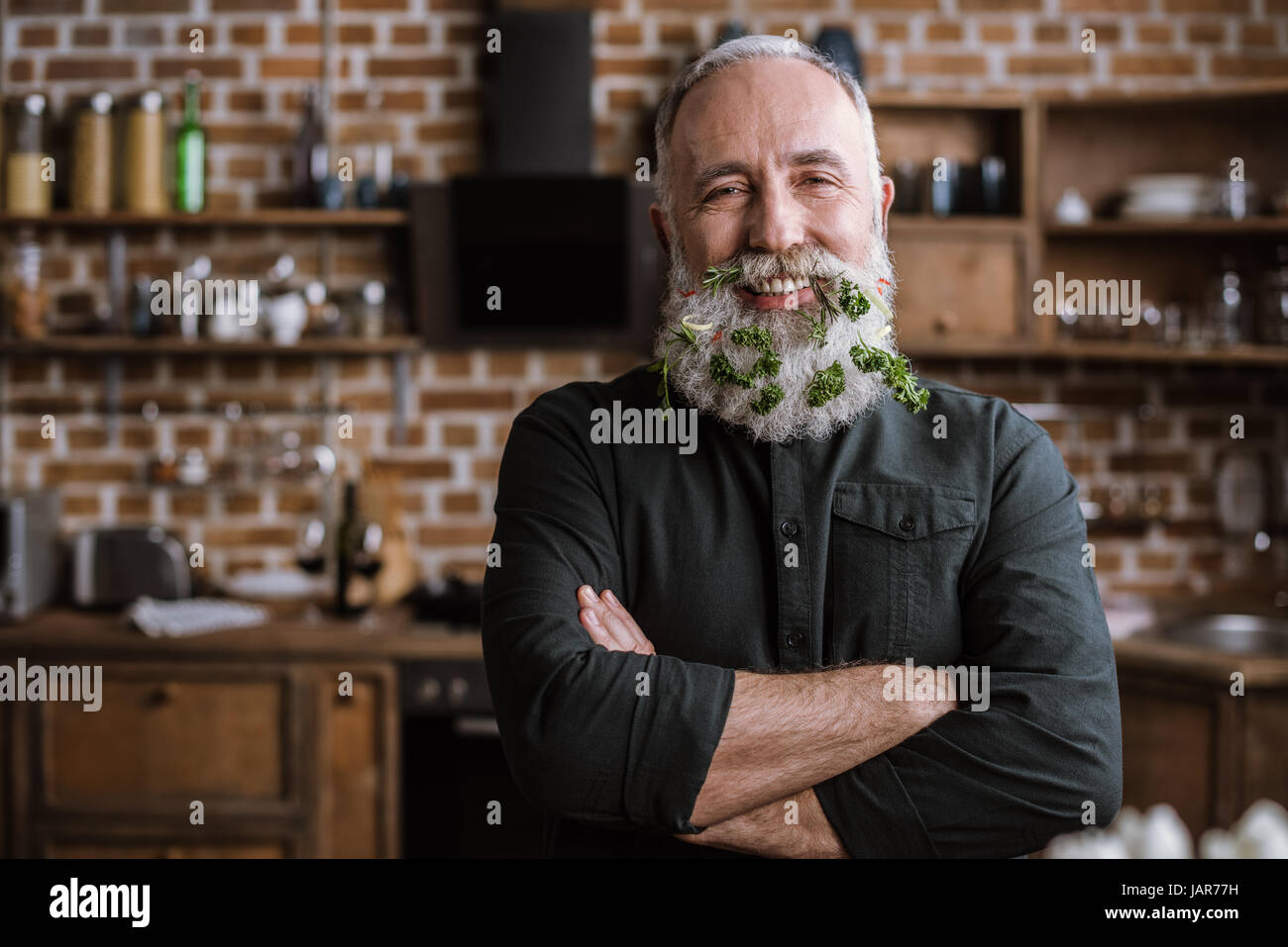 Senior man with greens in beard Stock Photo - Alamy