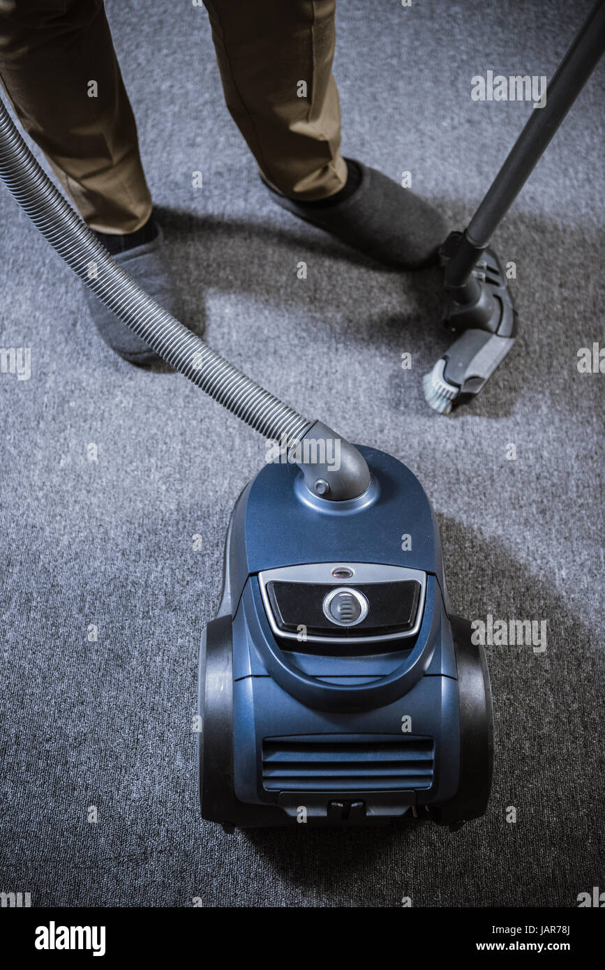 Man with vacuum cleaner Stock Photo - Alamy