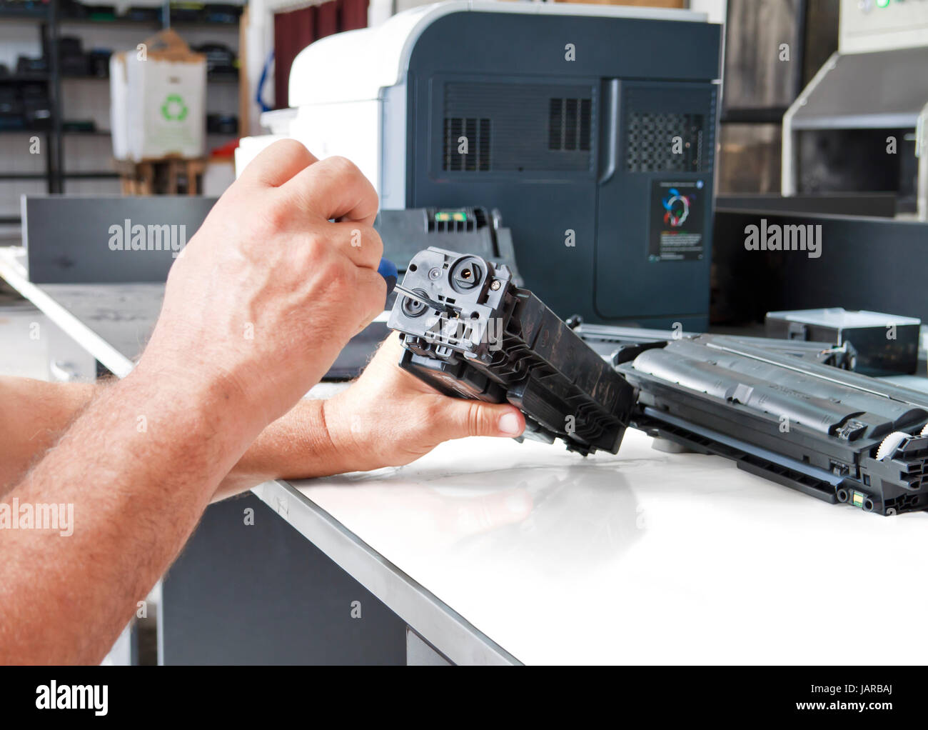 Hands repairing laser toner cartridge Stock Photo - Alamy