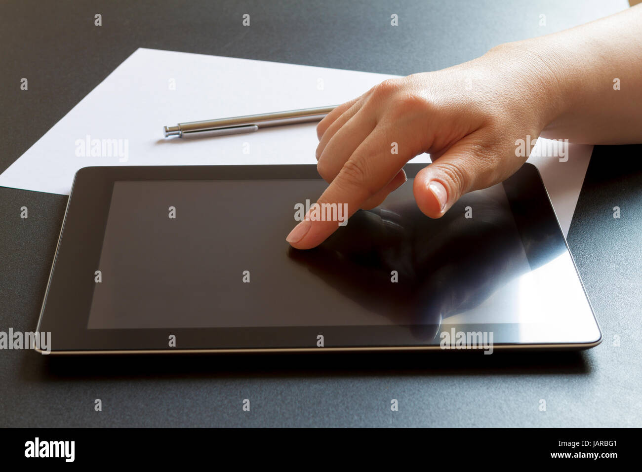 Woman hand typing on touch screen of digital tablet Stock Photo - Alamy