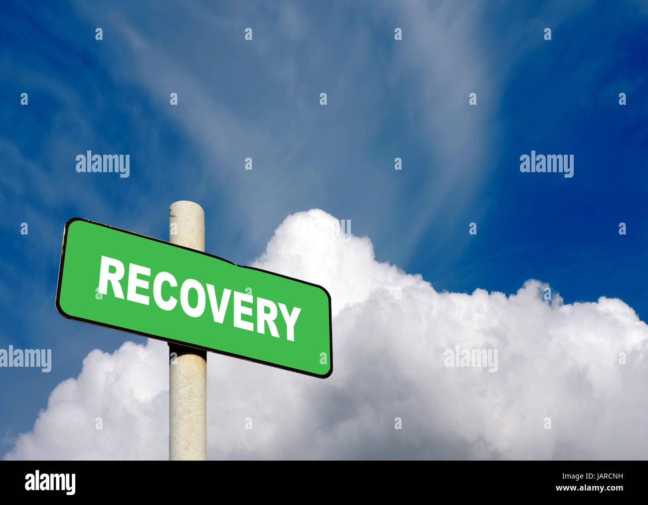 Green recovery sign against a blue sky Stock Photo - Alamy