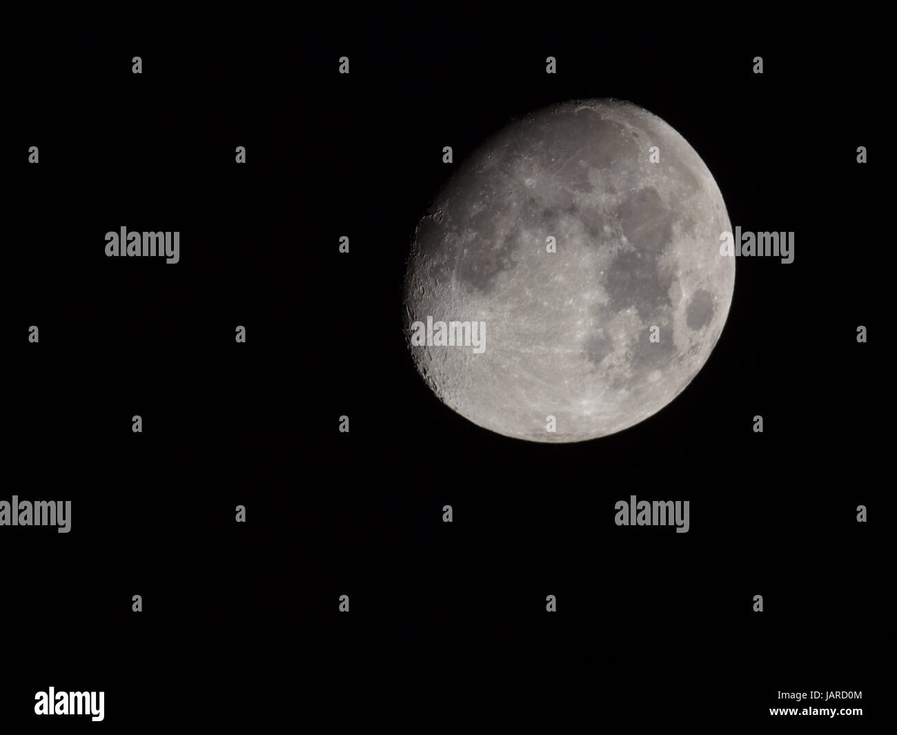 Near full moon seen with a telescope Stock Photo - Alamy