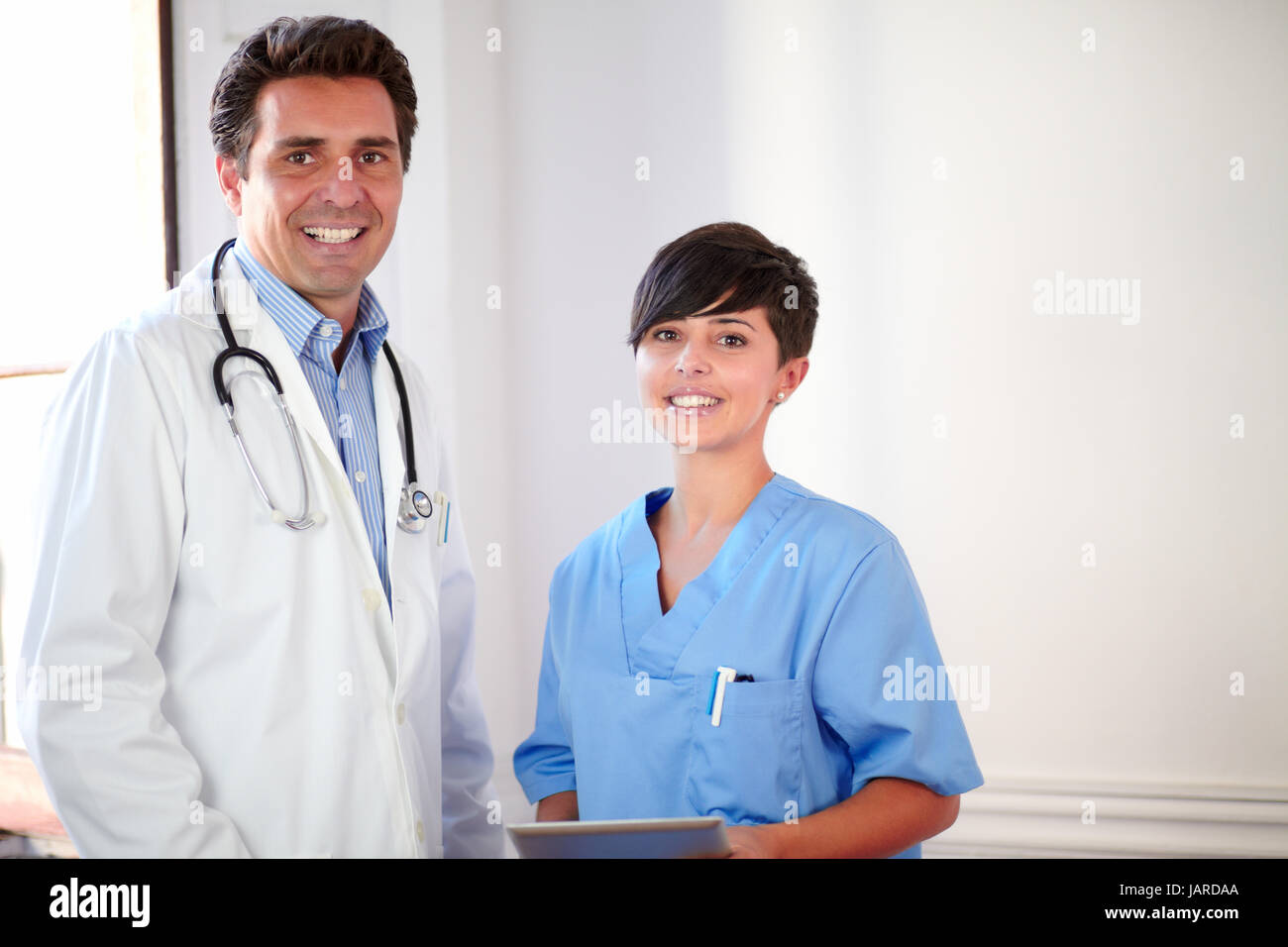 Portrait of a handsome latin doctor and beautiful nurse on medical ...