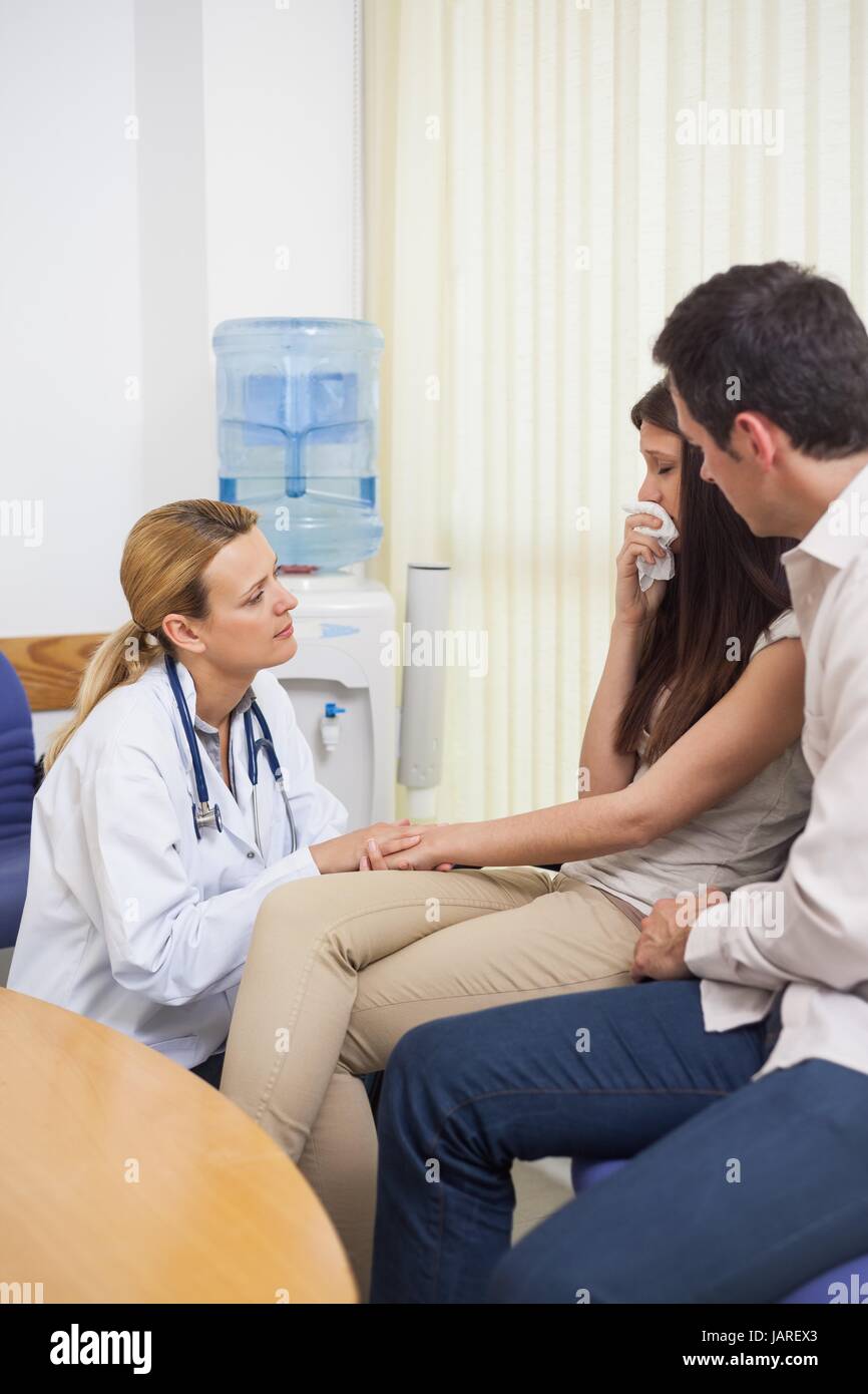 Doctor young couple crying sad hi-res stock photography and images - Alamy