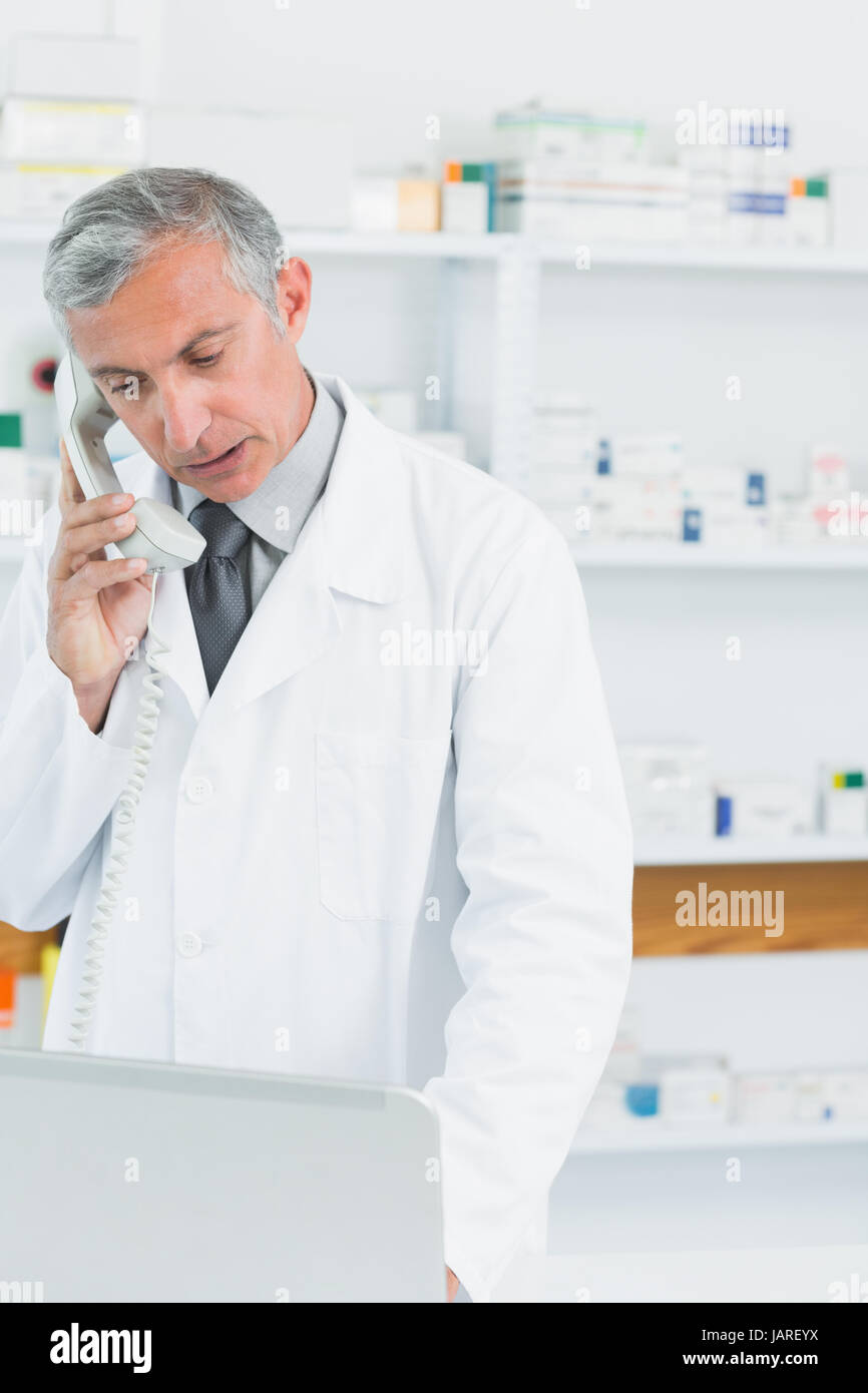 Pharmacist on the phone in a pharmacy in a hospital Stock Photo - Alamy
