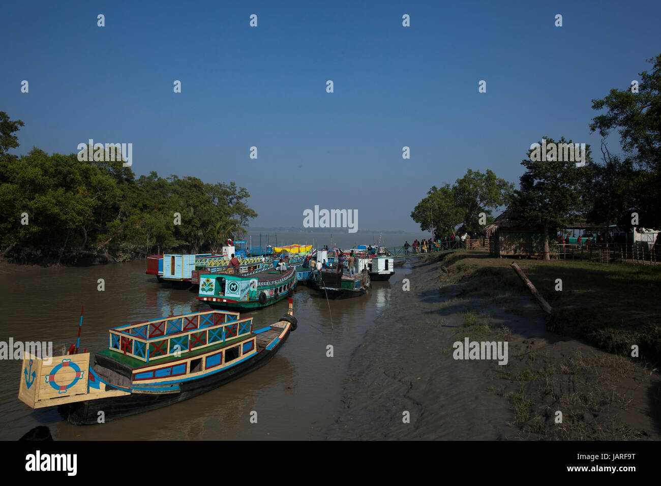 Small tourist boats on the canal in front of the Koromjol Eco Tourism ...