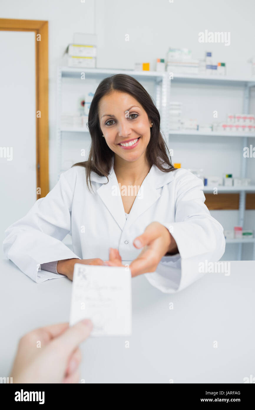 Happy female pharmacist receiving prescription hi-res stock photography ...