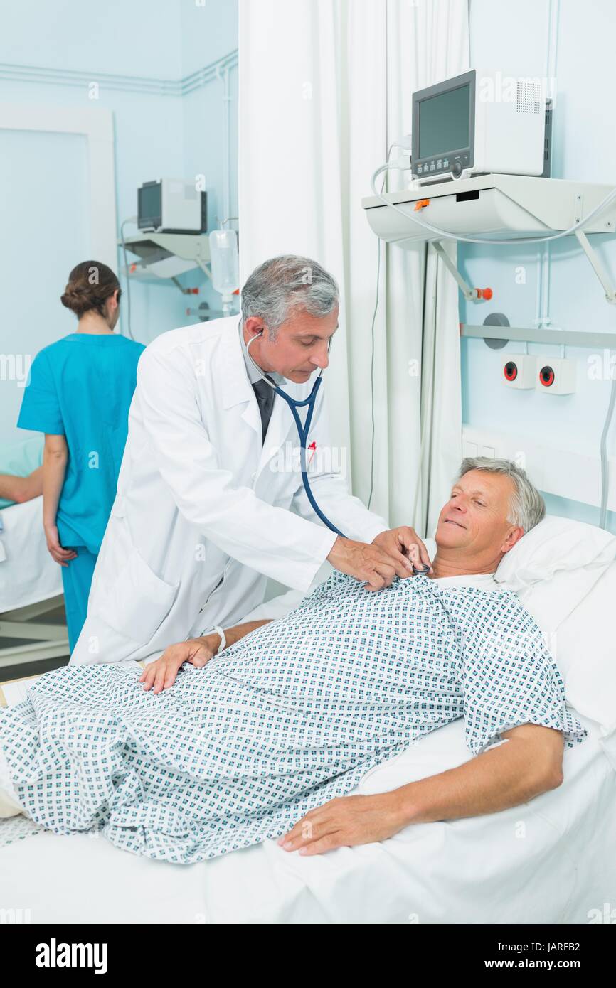 Auscultating patient with stethoscope hi-res stock photography and ...