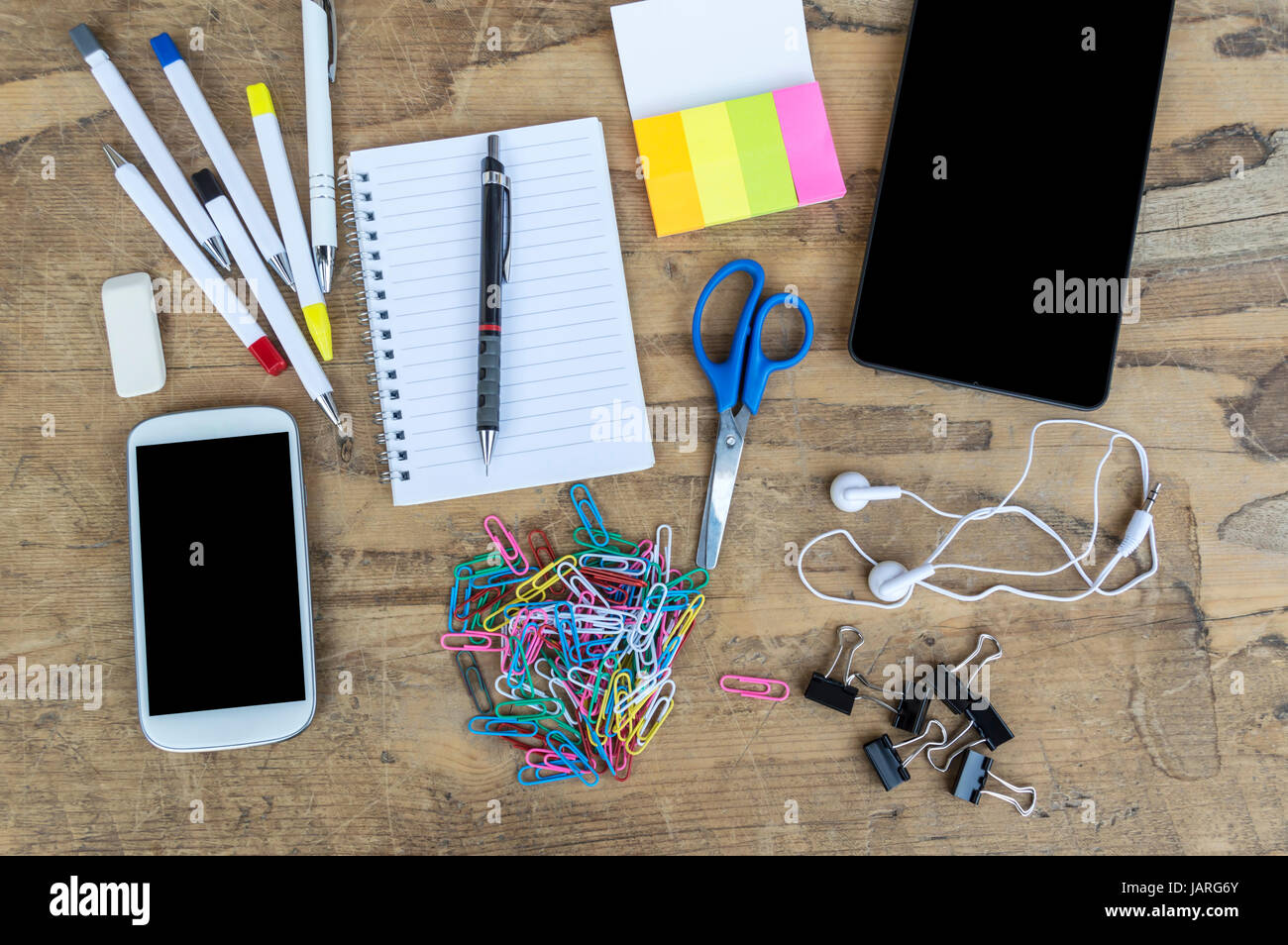 Desk above, table top view of stationery items - pen, pencil, sticky ...