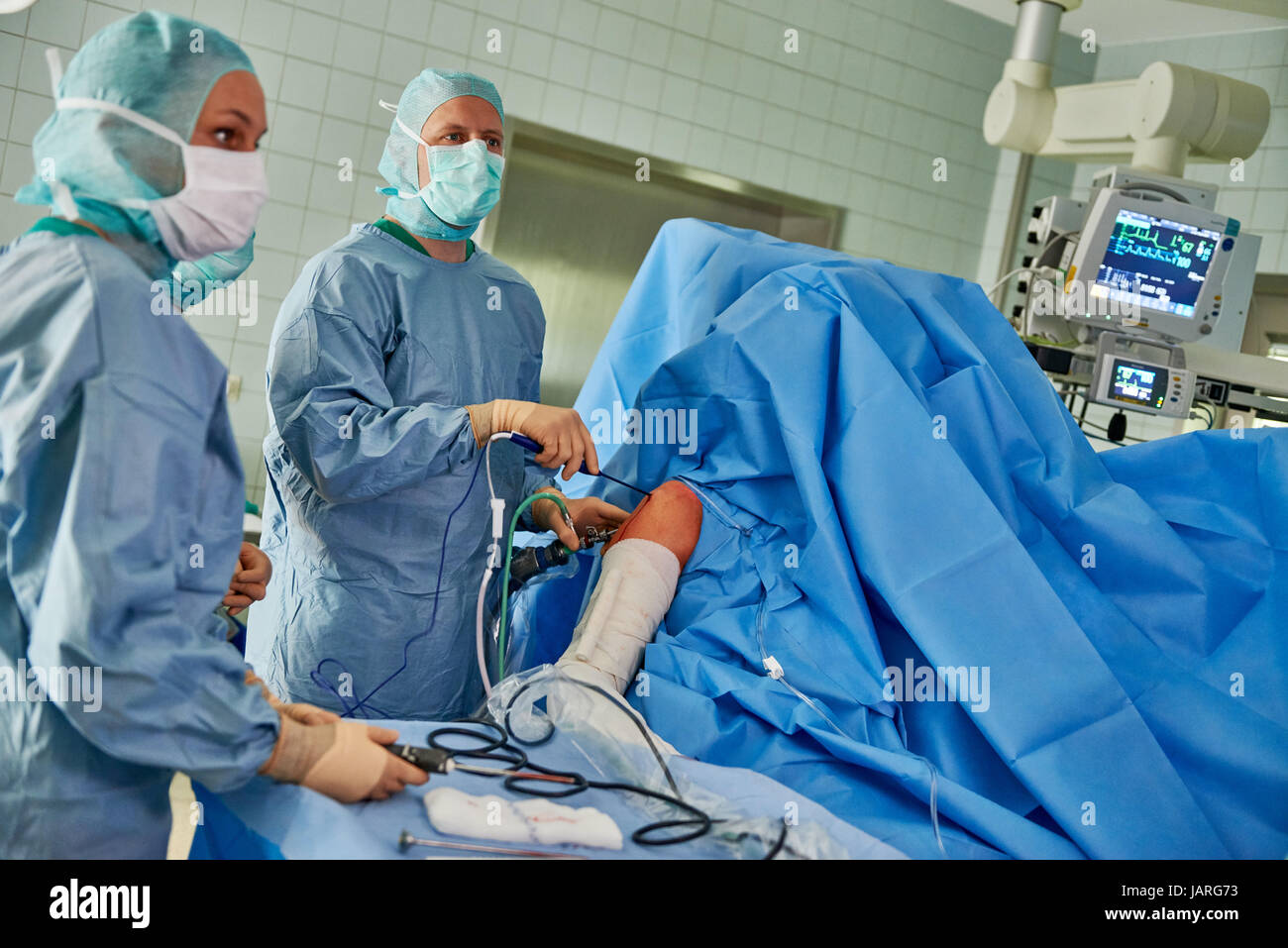 team of surgeons and nurses performing laparoscopic minimally invasive ...