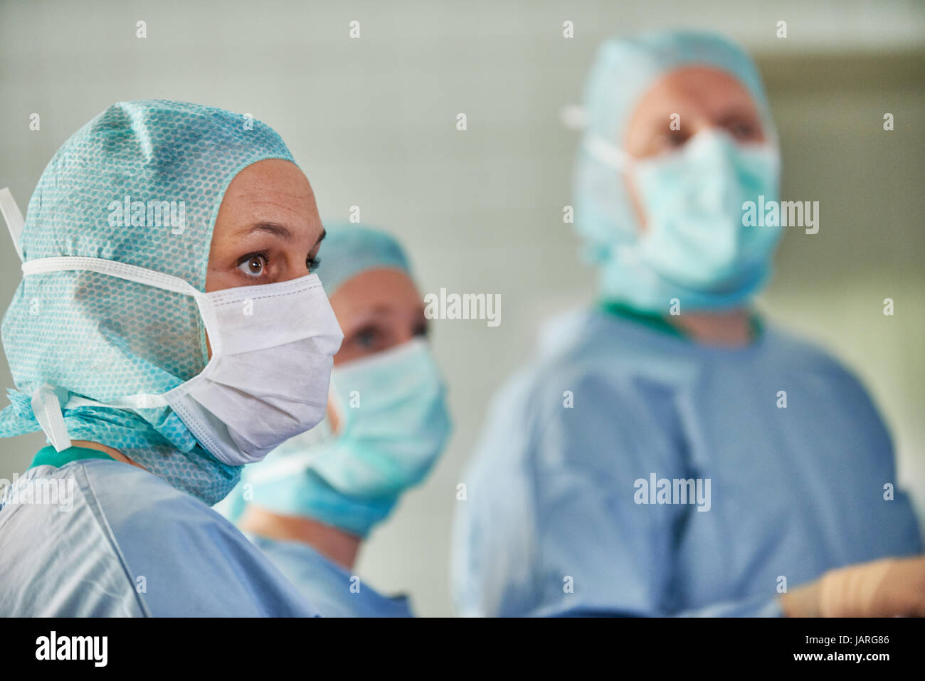 team of surgeons and nurses performing laparoscopic minimally invasive ...