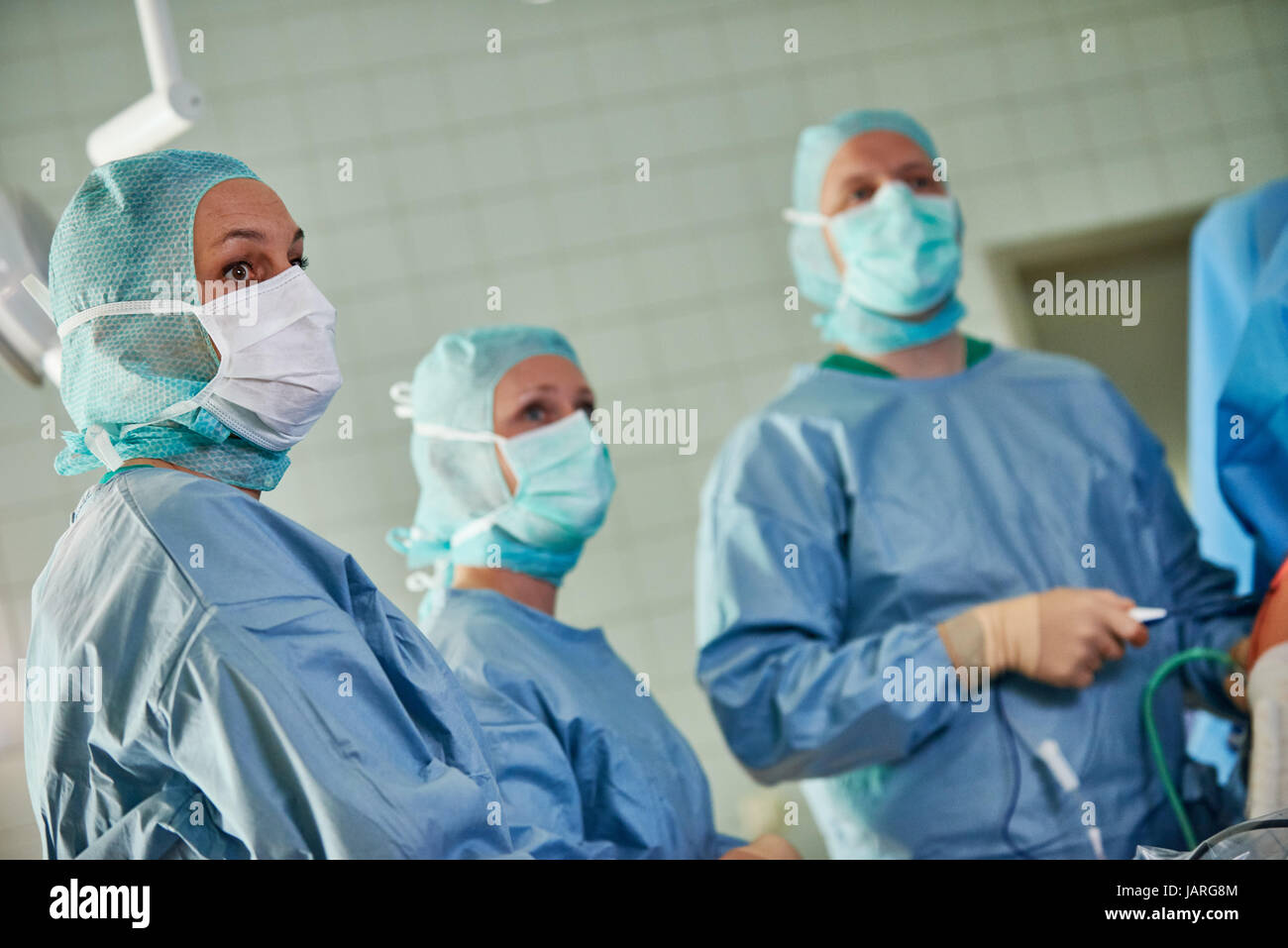 team of surgeons and nurses performing laparoscopic minimally invasive ...