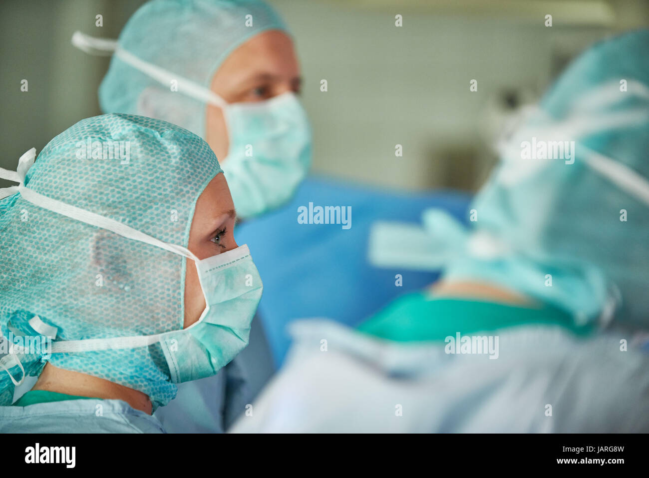 team of surgeons and nurses performing laparoscopic minimally invasive ...