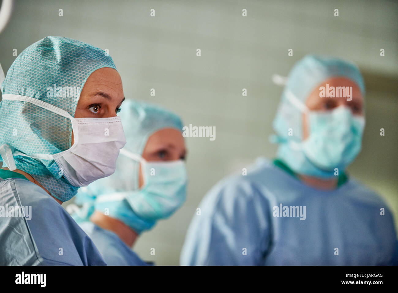 team of surgeons and nurses performing laparoscopic minimally invasive ...