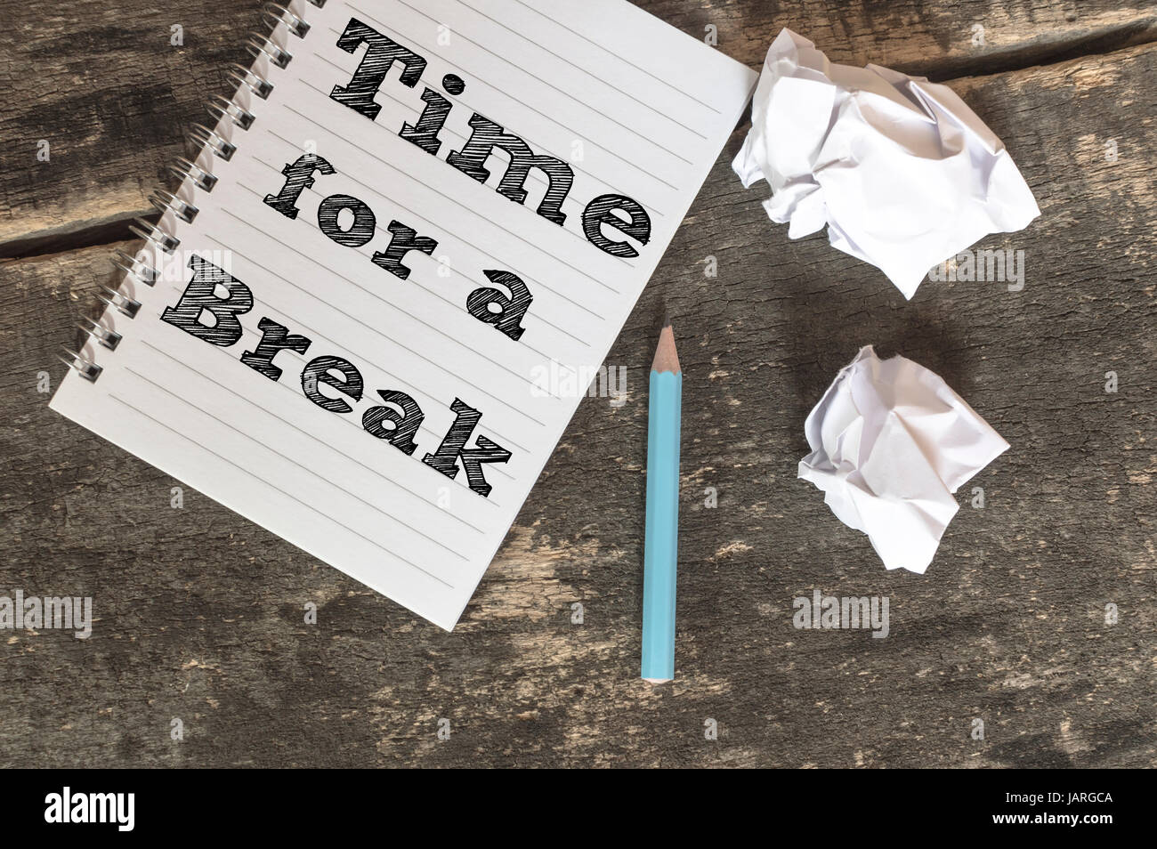Time for a Break on a notebook with pen crumpled paper on wooden table ...