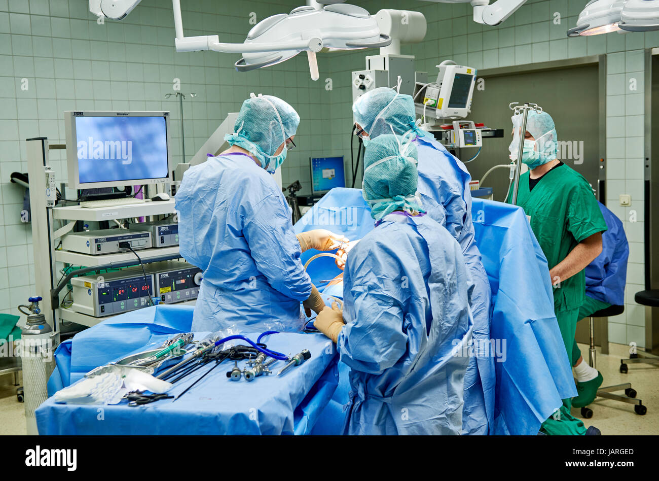 team of surgeons and nurses performing laparoscopic minimally invasive ...