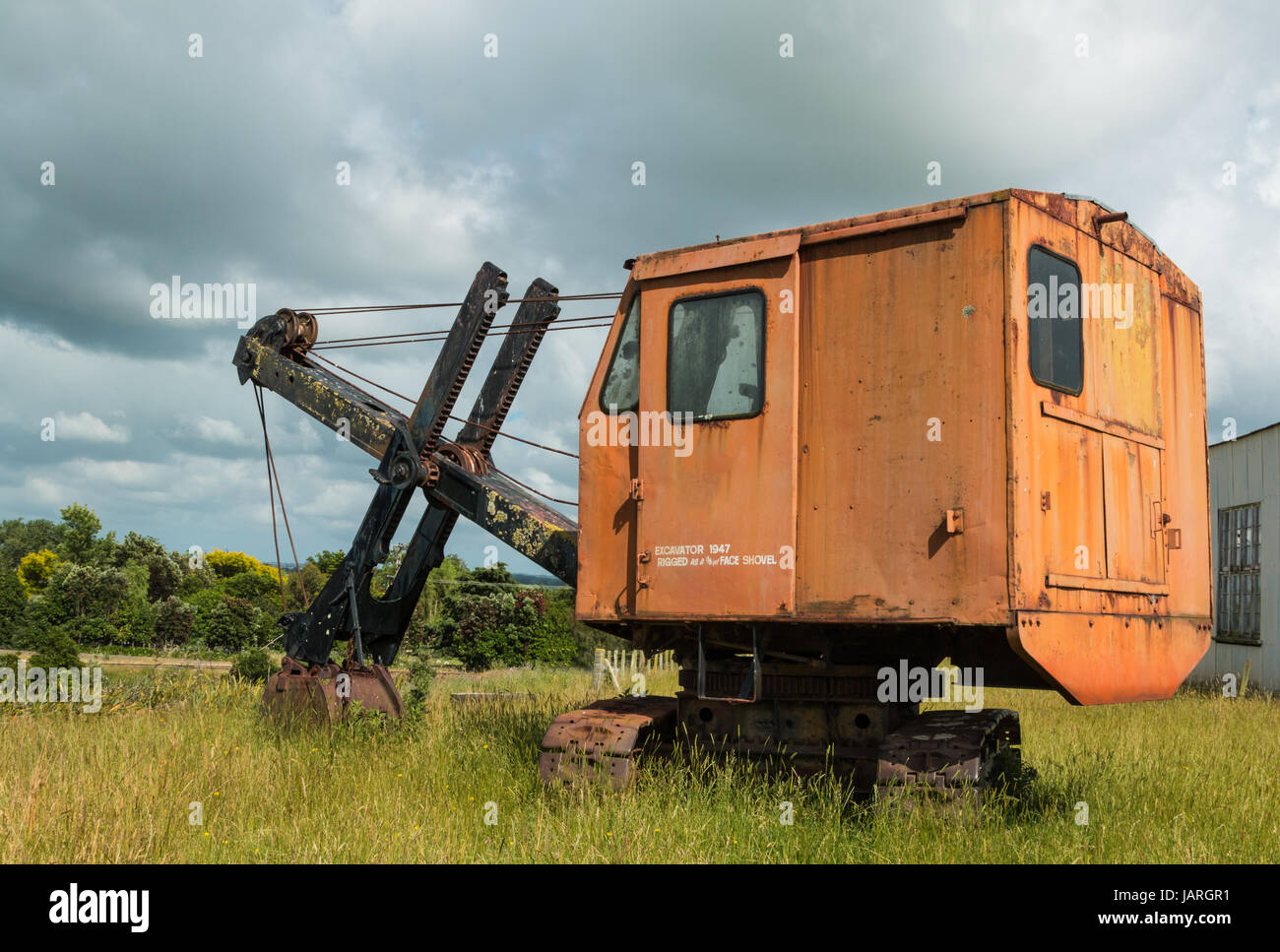 One old digger now resting in green pastures Stock Photo - Alamy