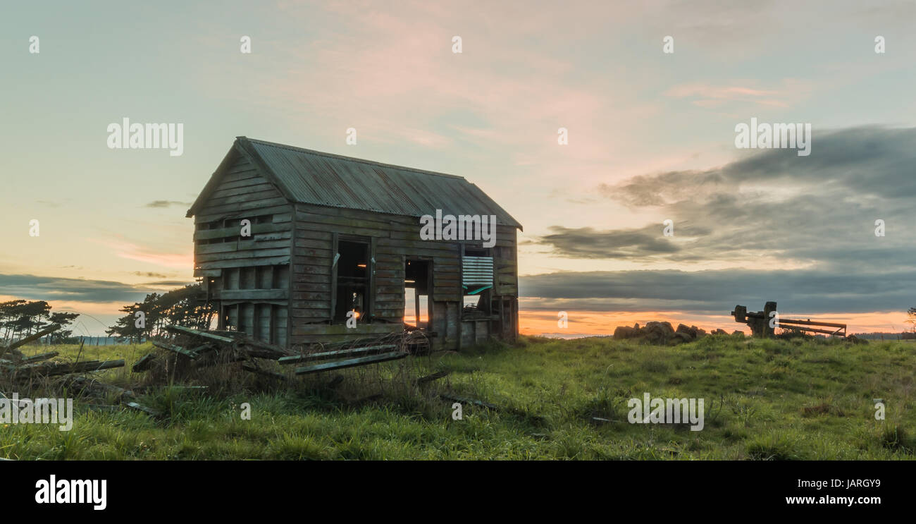 Small old farm house just rotting away, with a morning sky bind it ...