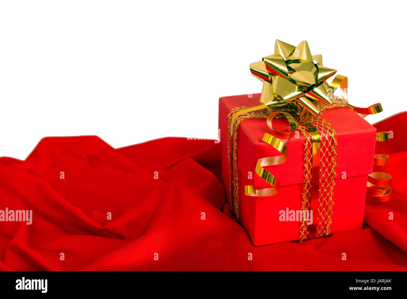Gift box of red color on a red fabric Stock Photo - Alamy