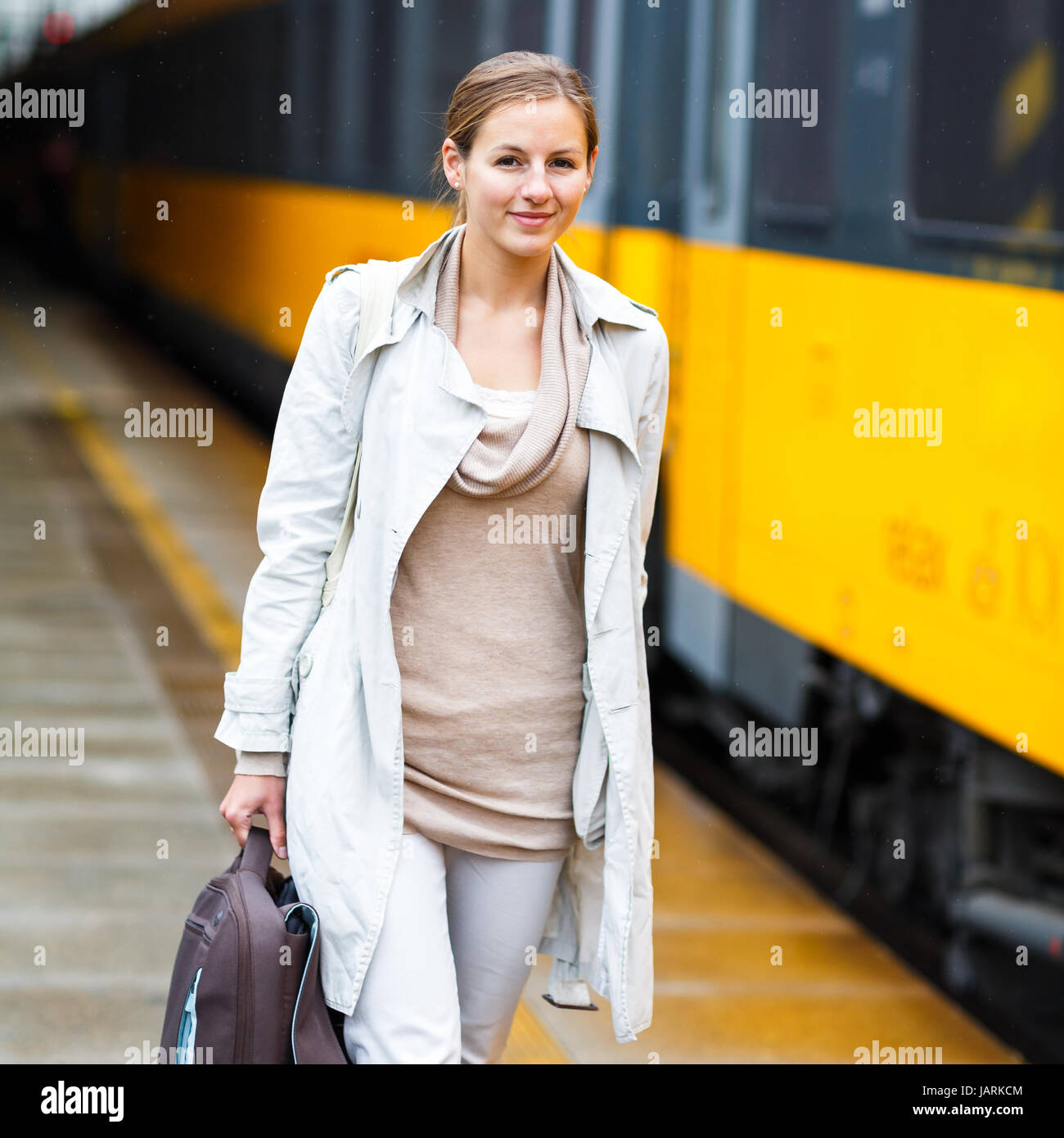 Pretty young woman at a train station (color toned image Stock Photo ...
