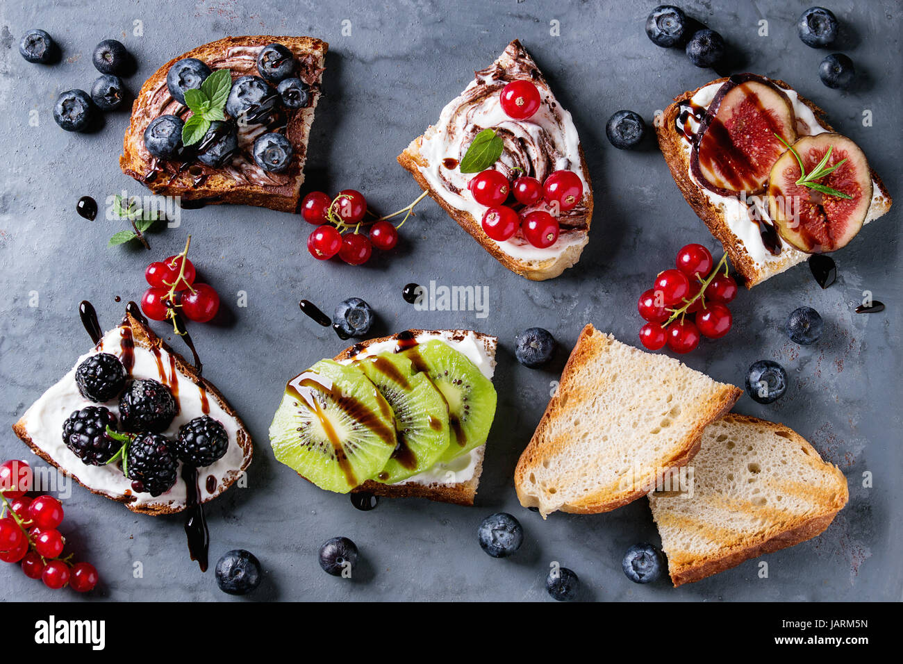 Variety of dessert sandwiches with berries and cream cheese and ...