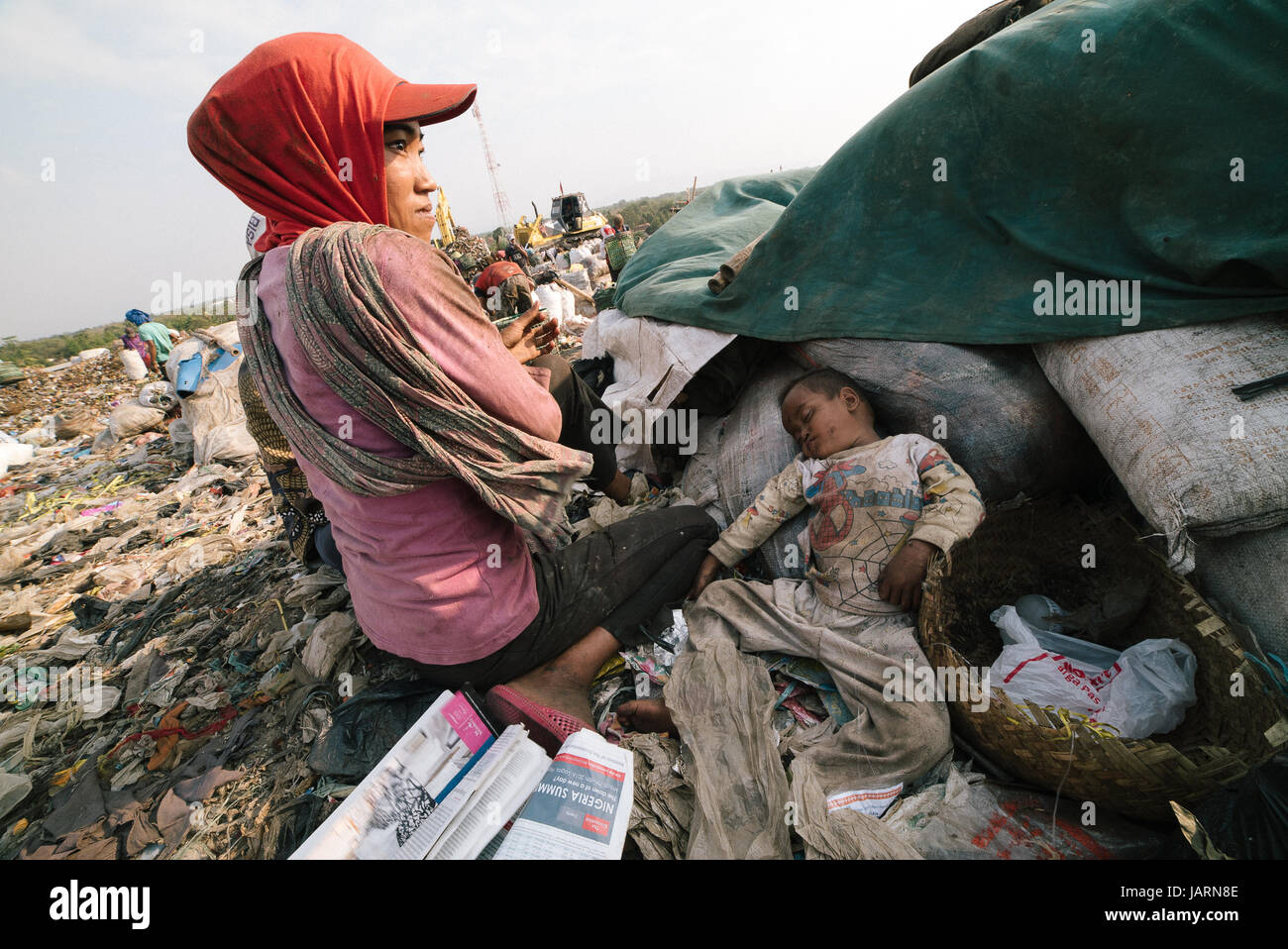A boy Sleeping in Mountain of Trash in Bantar Gebang, Bantar Gebang is ...