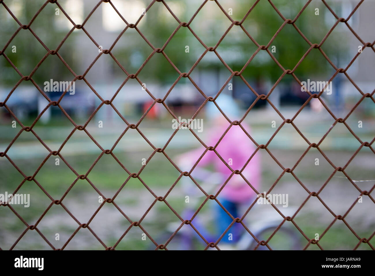 Protective grid around the playground in the city Stock Photo - Alamy