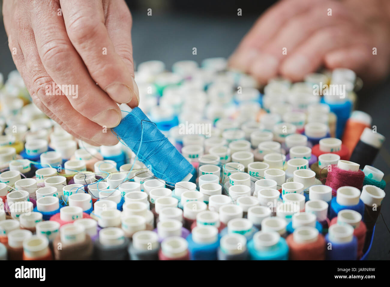 Tailors Hand Holding Sewing Spool Stock Photo - Alamy