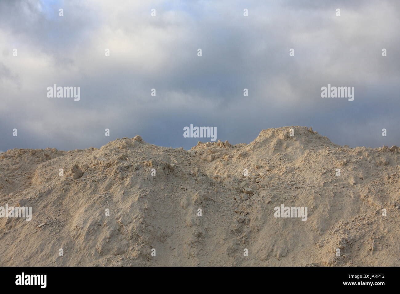 gypsum heap against blue and white sky Stock Photo - Alamy