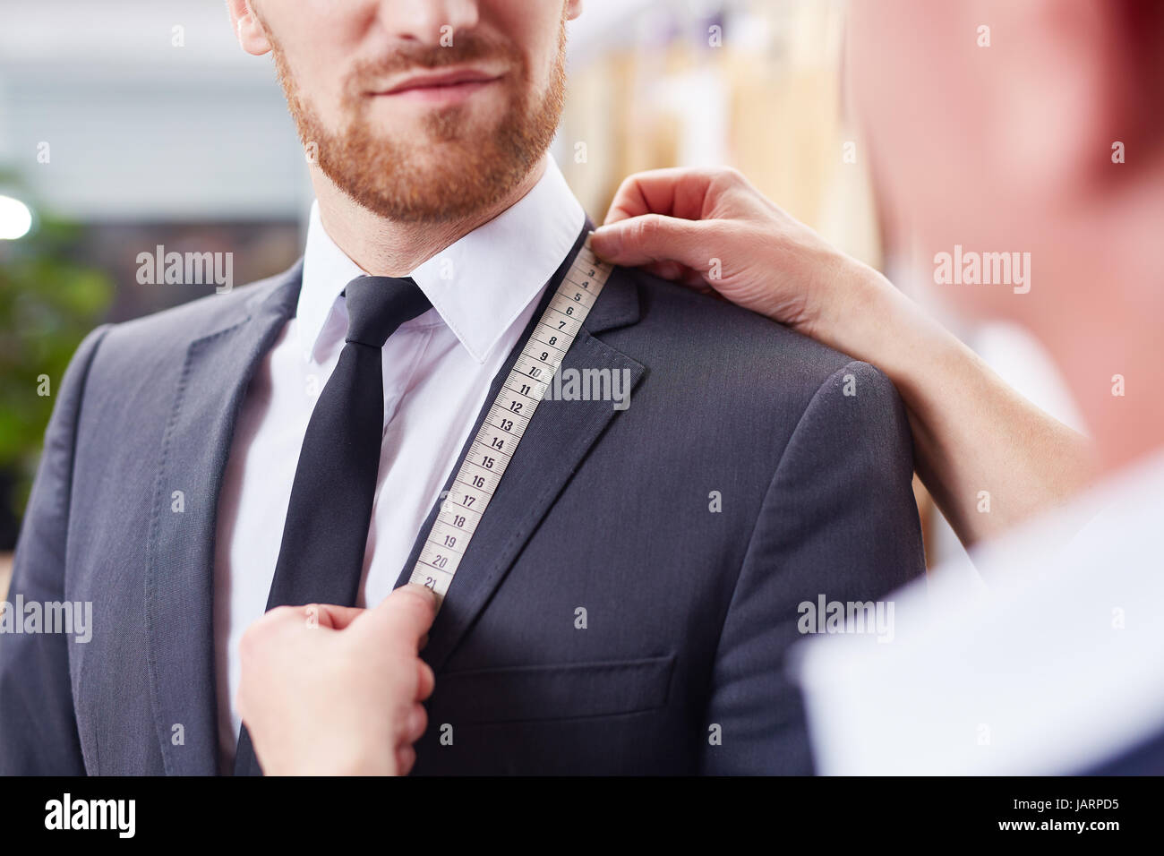 Tailor Taking Measurements in Atelier Stock Photo - Alamy